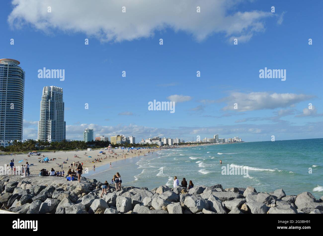 Local people swimming and gathering at Miami Beach near the pier on a ...