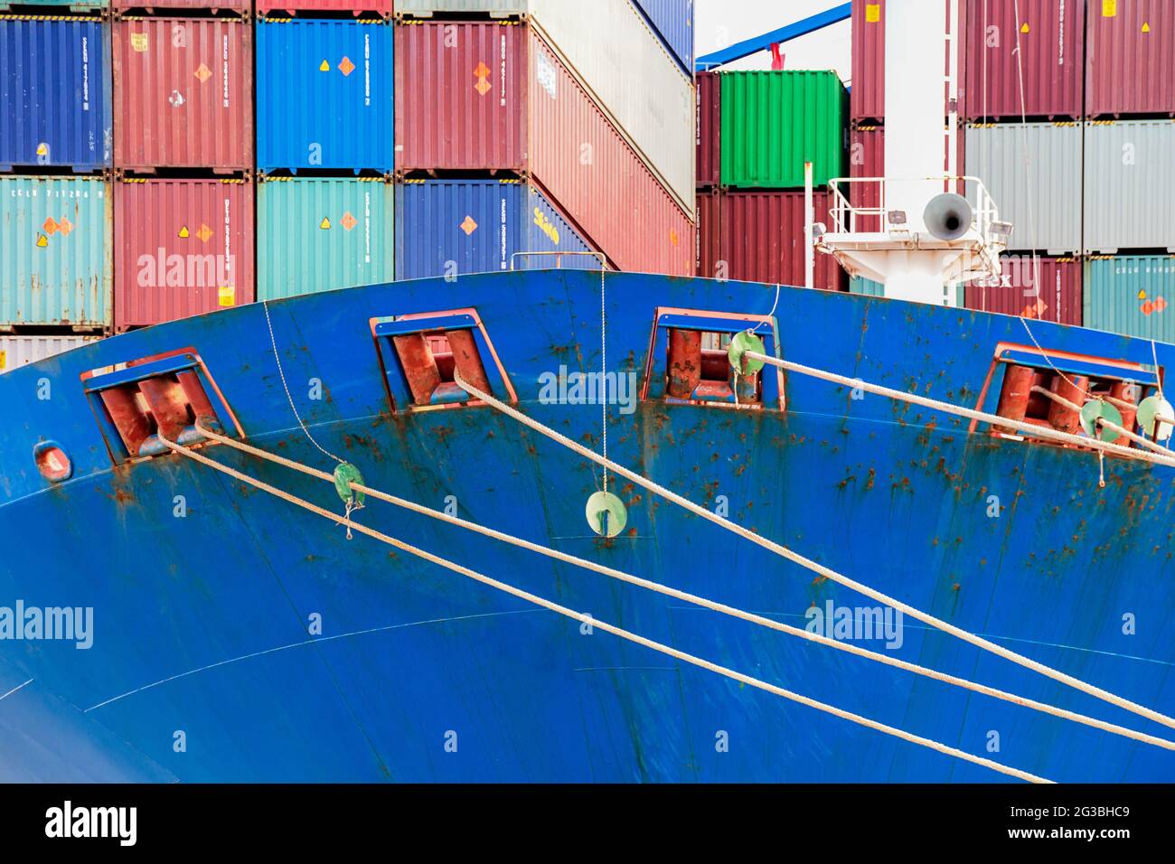 close-up view of the front of a container vessel with coloured ...