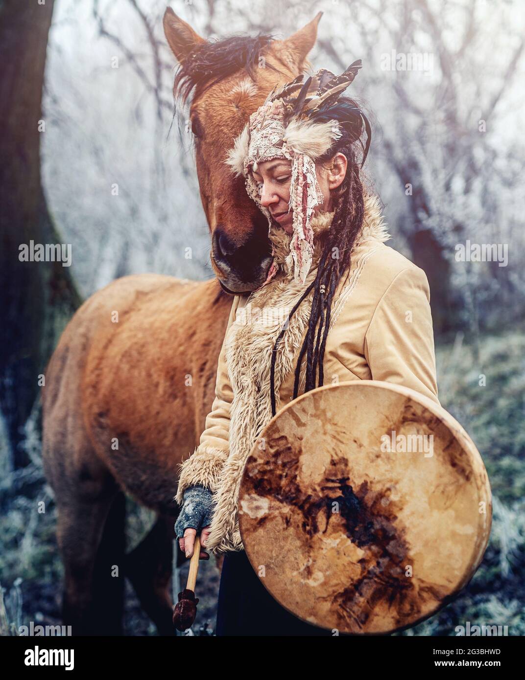 Shaman woman in winter landscape with her horse Stock Photo - Alamy