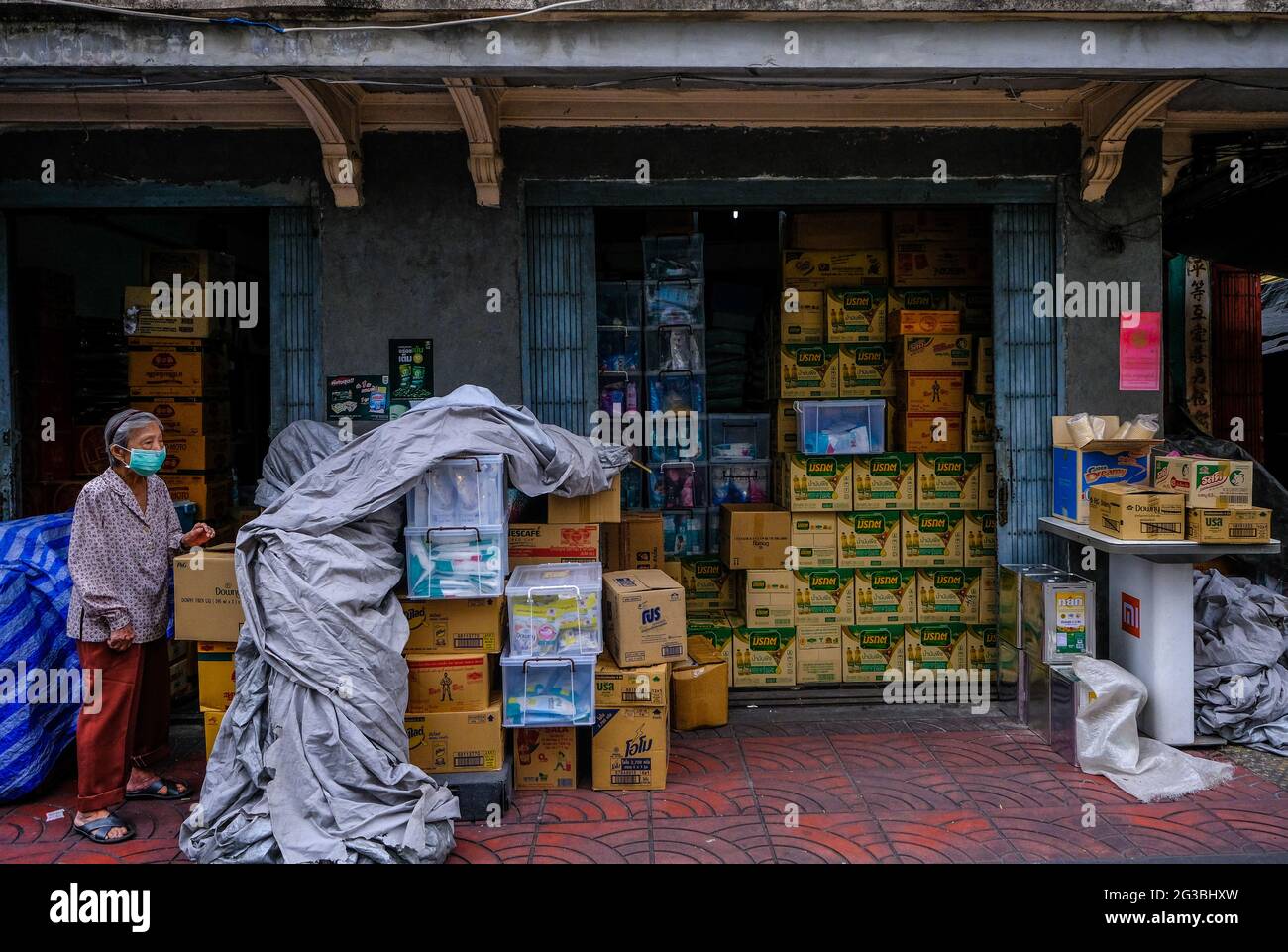 An elderly female shopkeeper stands outside her premises in Chinatown ...
