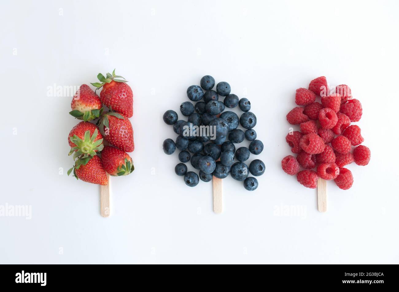 Fruit berry flavoured ice lolly stick concept, strawberry, blueberry ...