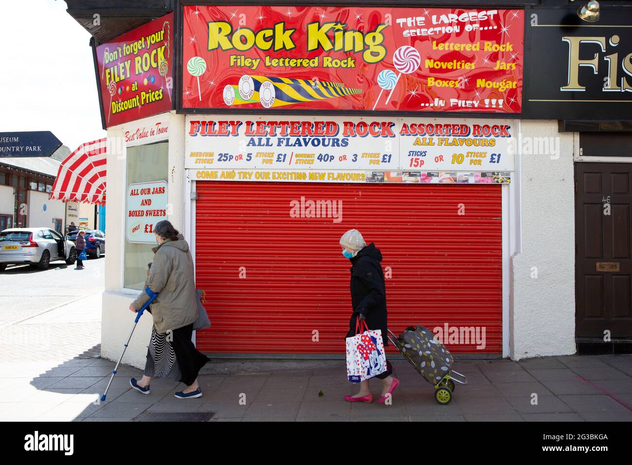 Elderly people walk past the ‘Rock King’ shop which sells lettered Rock ...