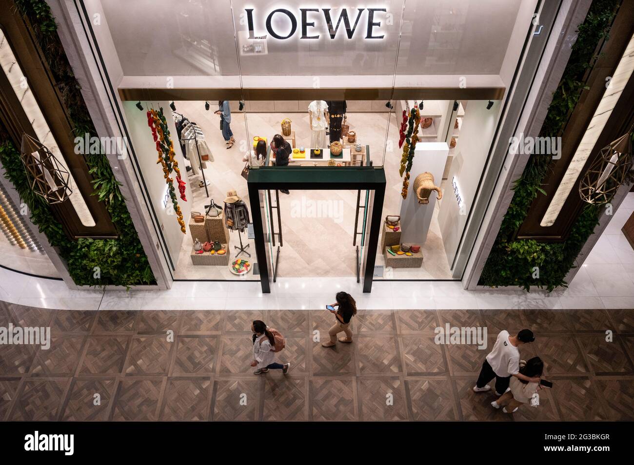 Shoppers walk past the Spanish luxury clothing and accessories brand ...