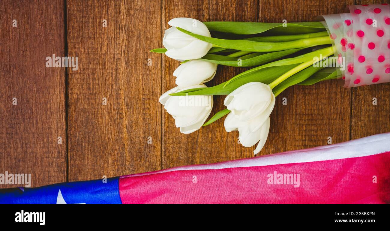 American flag and white tulip flowers on wooden background Stock Photo ...