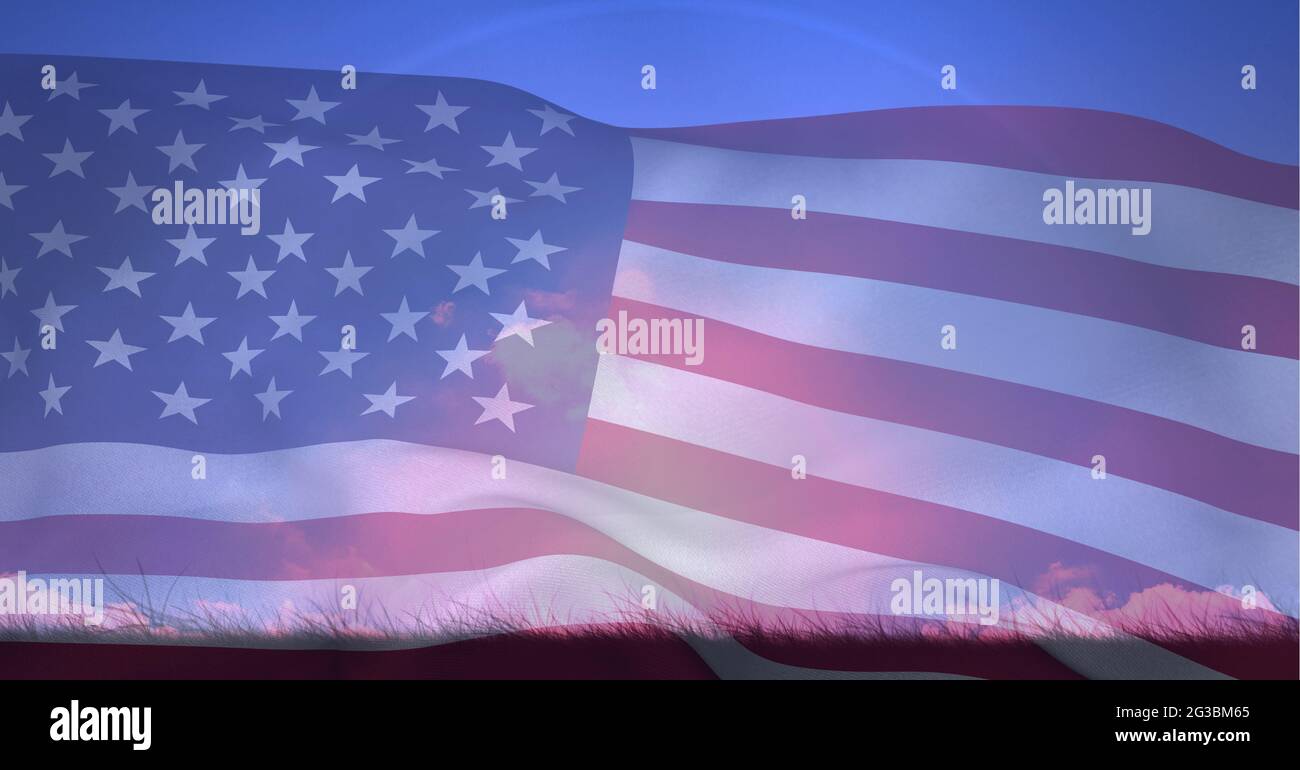 Composition of american flag billowing over grassy horizon and blue sky ...