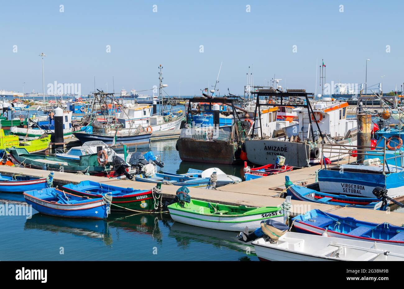 View of the small fishing port of Setubal with its typical blue boats ...