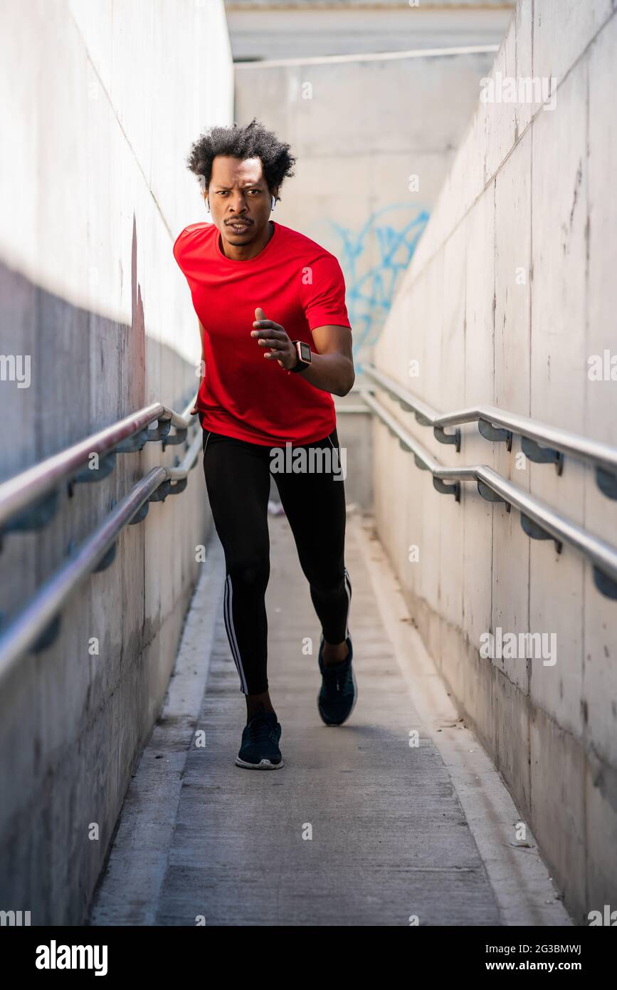 Athletic man running and doing exercise outdoors Stock Photo - Alamy