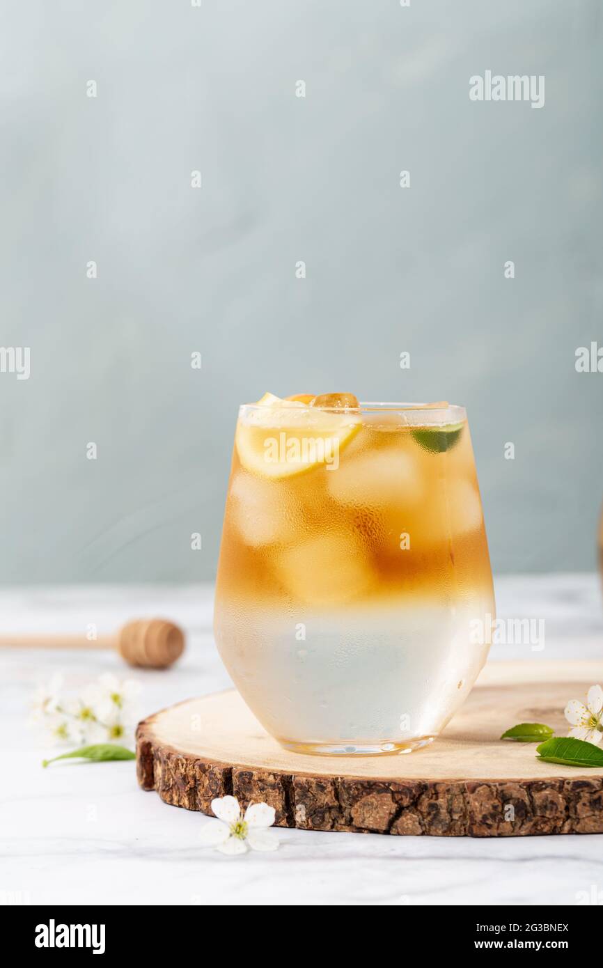 Vertical shot of a cold refreshing glass of lemonade with ice cubes on a wooden board Stock ...
