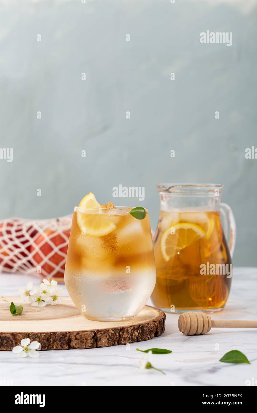 Vertical shot of a cold refreshing glass of lemonade with ice cubes on ...