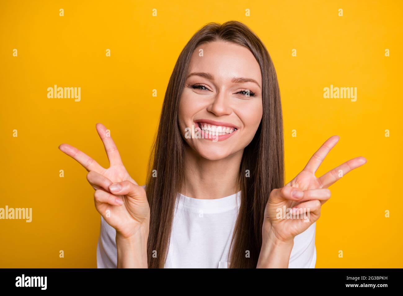 Photo portrait of excited smiling girl showing two v-signs isolated on ...
