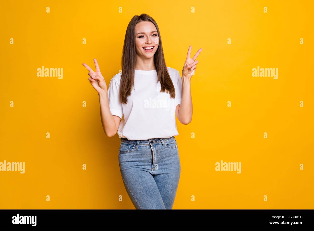 Photo portrait of woman showing two v-signs smiling isolated on vivid ...