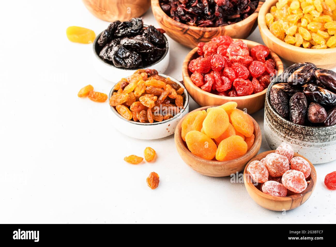 Healthy food snacks: natural dried fruits mix in bowls on white ...