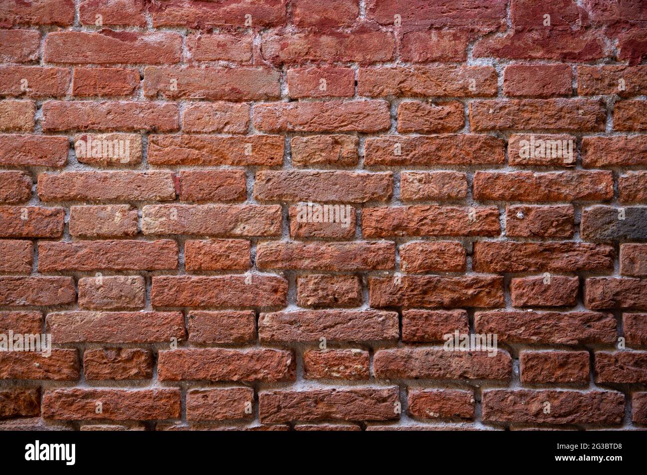 Old red hand made brick wall made from narrow long bricks wall ...