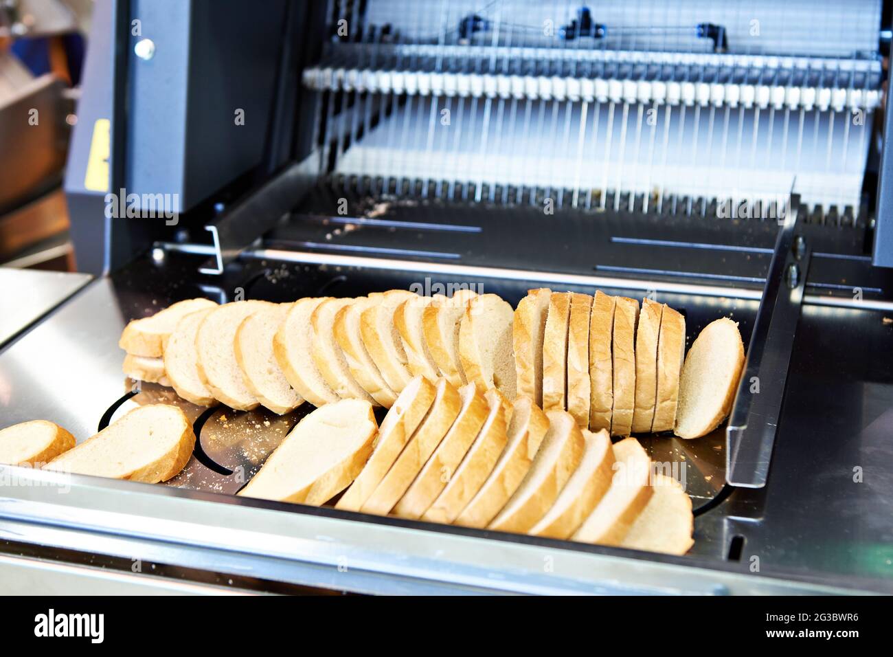 Sliced white bread in a cutting machine Stock Photo - Alamy