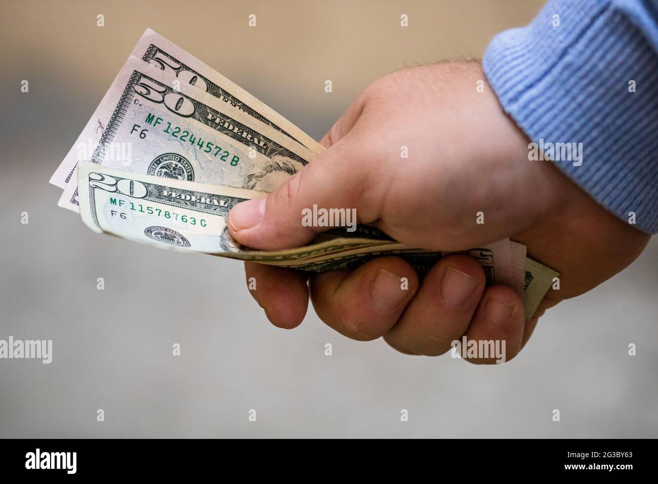 Selective focus on detail of USD banknotes. Counting or giving United ...