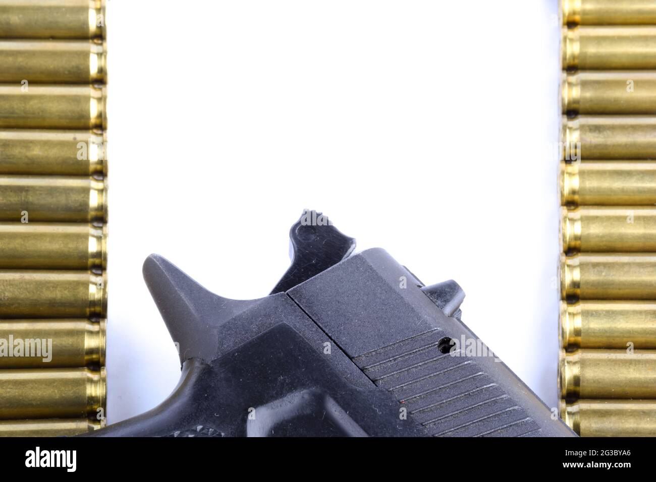 Cartridges for a traumatic gun on both sides of a photo and a gun on a ...