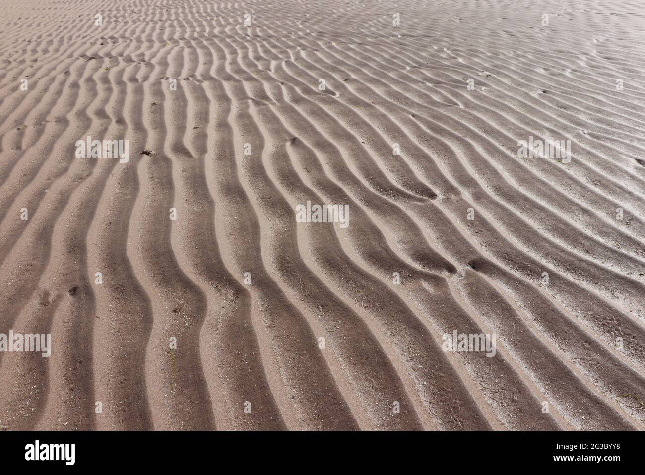 Lines, patterns and shapes in sand, formed by the tidal movement of the ...