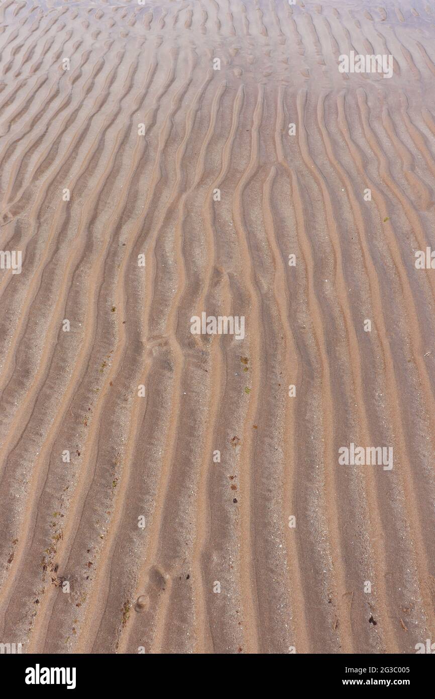 Lines, patterns and shapes in sand, formed by the tidal movement of the ...