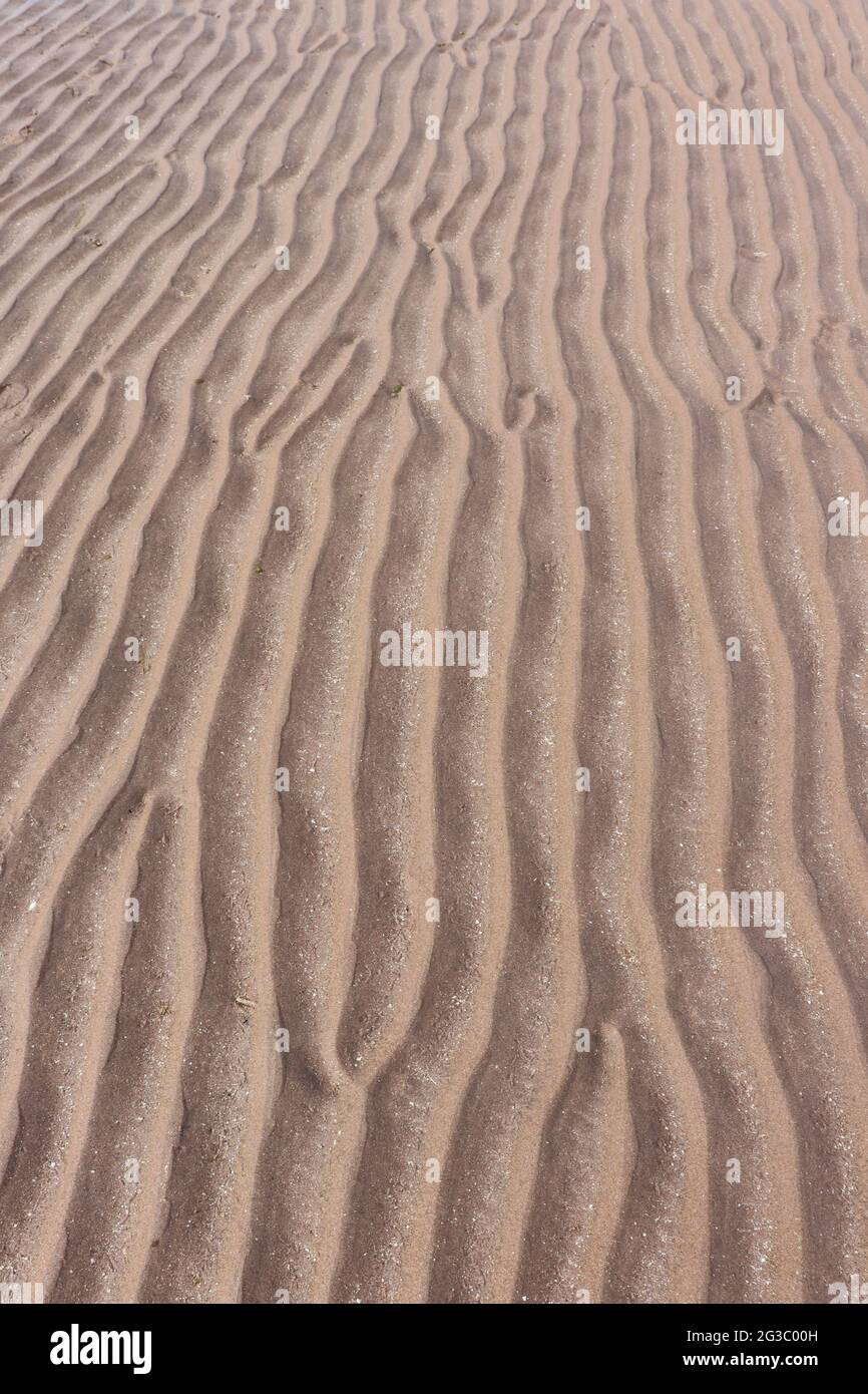 Lines, patterns and shapes in sand, formed by the tidal movement of the ...