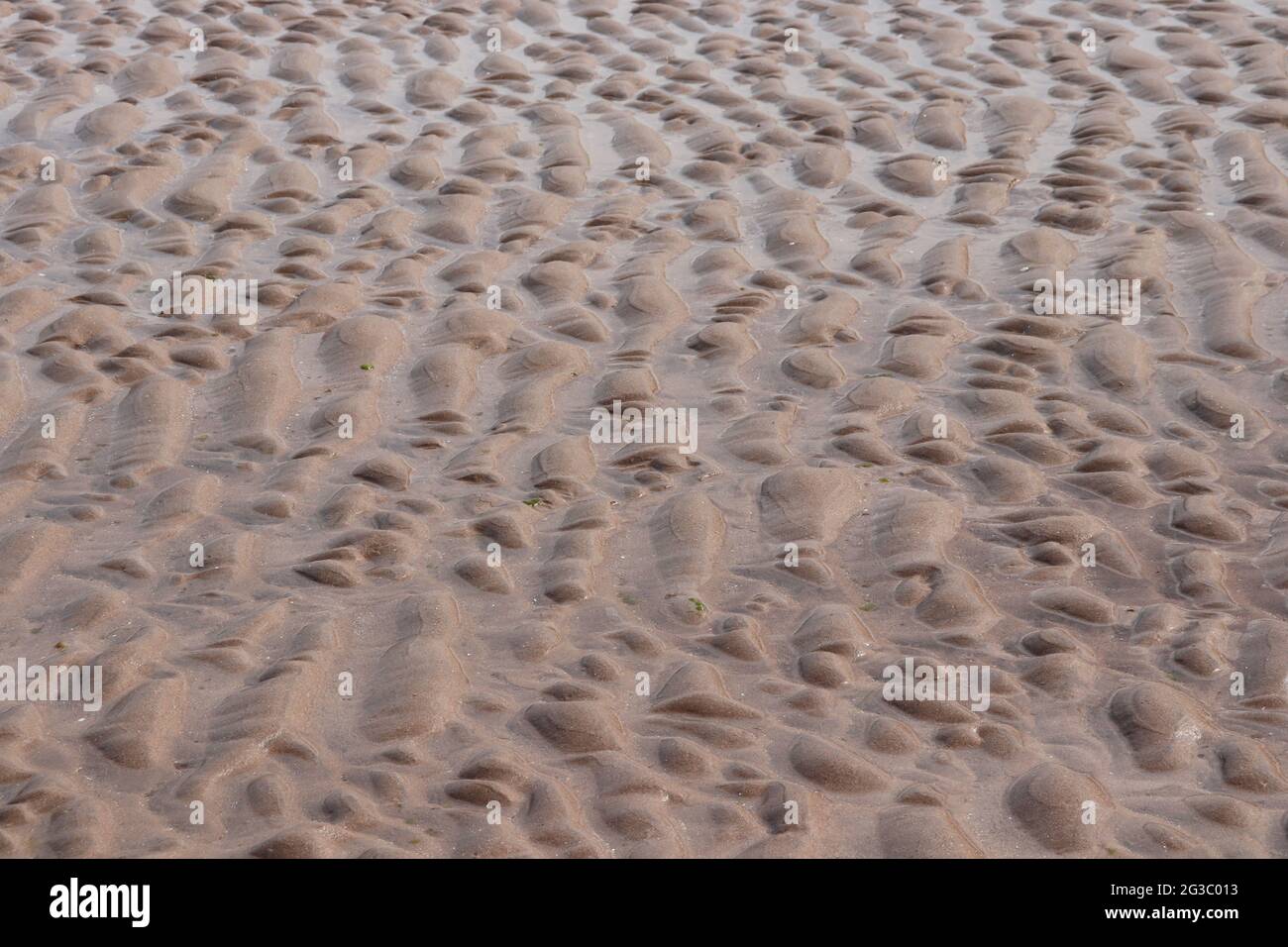 Lines, patterns and shapes in sand, formed by the tidal movement of the ...