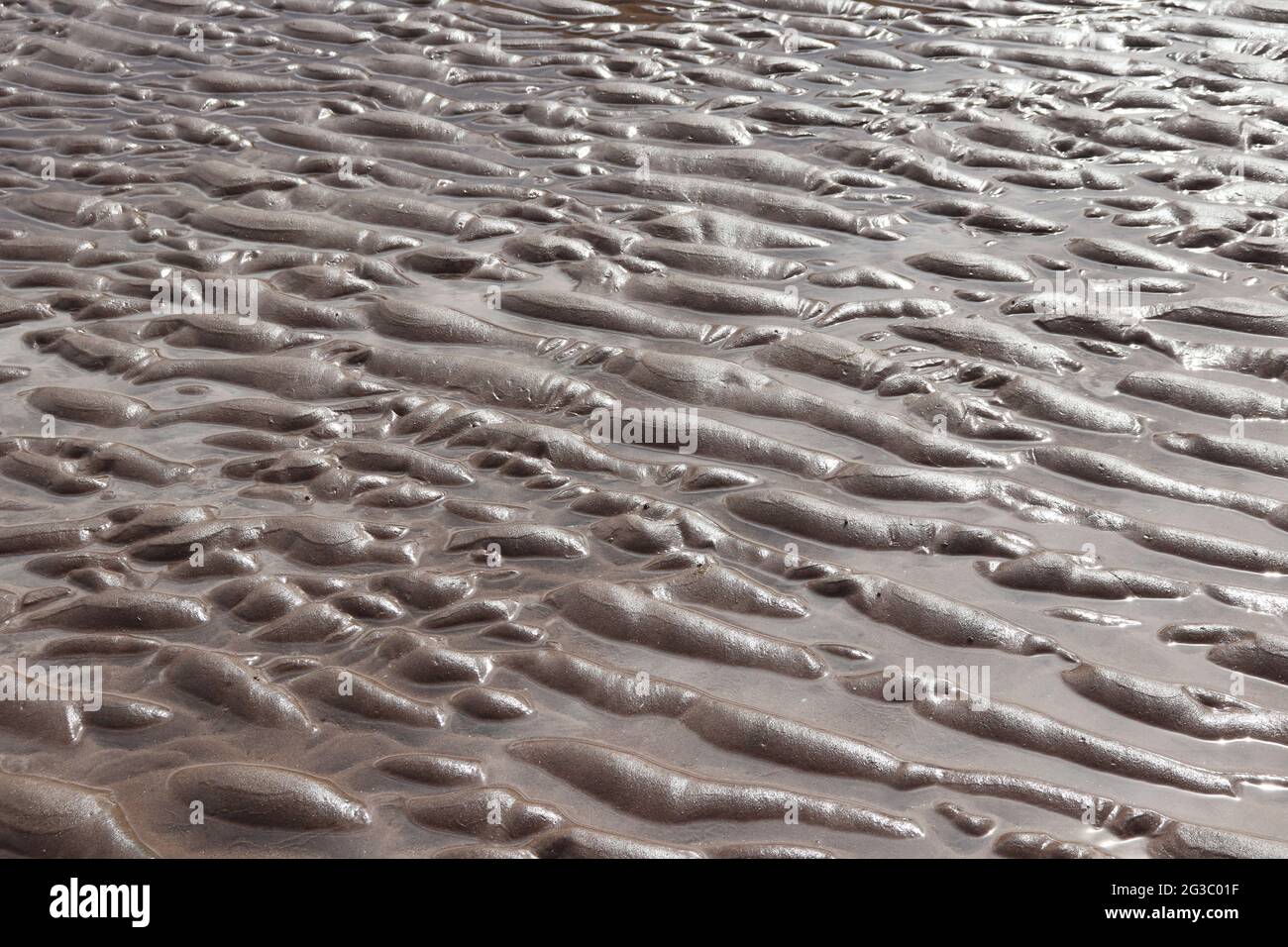 Lines, patterns and shapes in sand, formed by the tidal movement of the ...