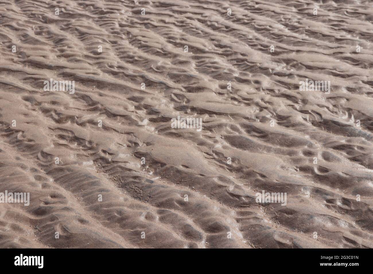 Lines, patterns and shapes in sand, formed by the tidal movement of the ...