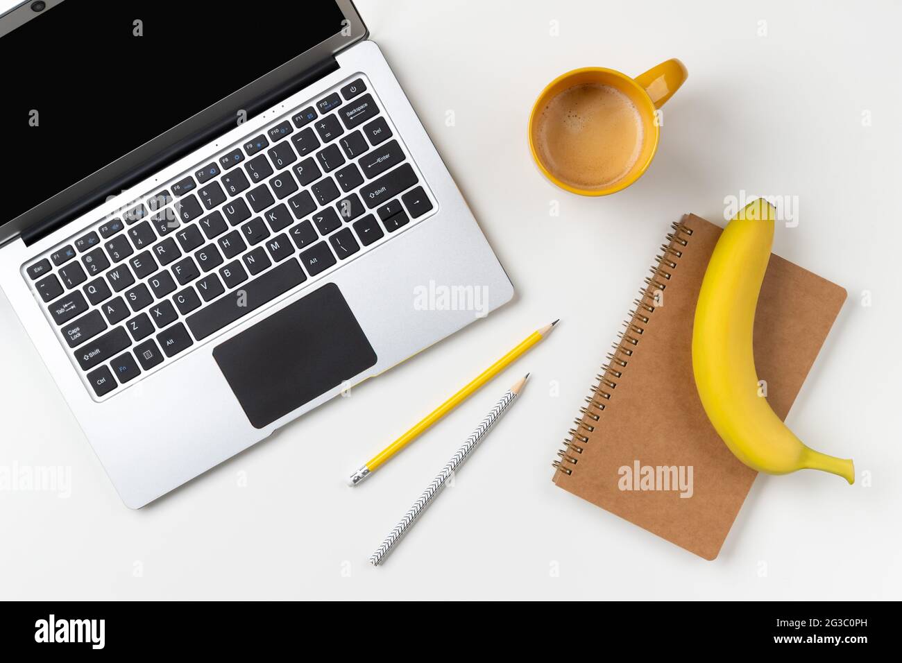 Flat lay top view modern laptop, food and stationery on white table ...