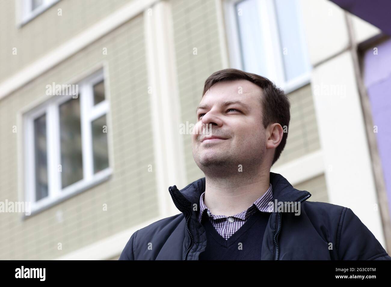 Happy man is posing in residential district Stock Photo - Alamy