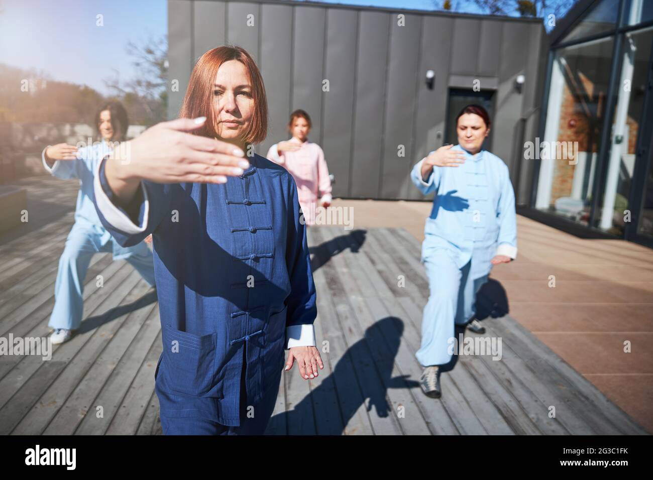 People meditating while putting one hand forward Stock Photo - Alamy