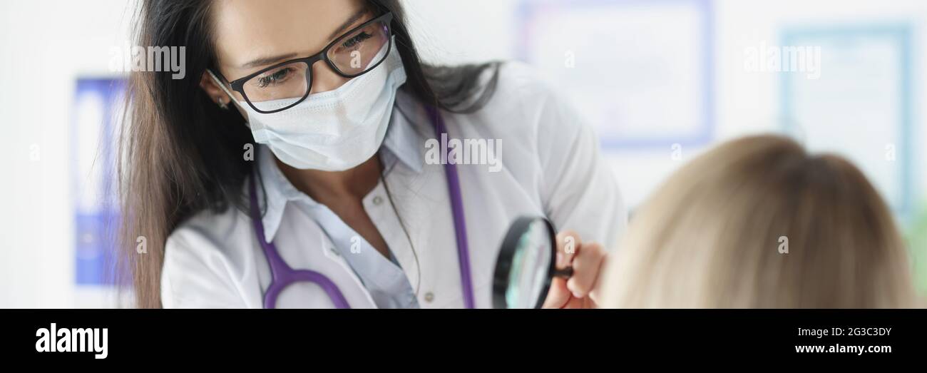 Doctor examining skin on patients face using magnifying glass Stock ...