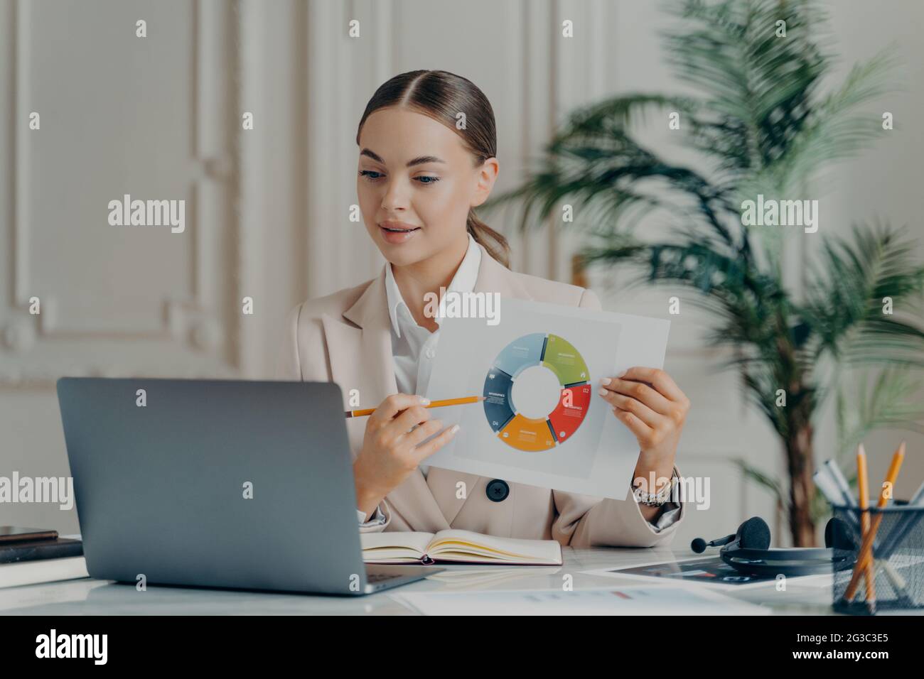 Female economist showing statistical data during meeting Stock Photo ...