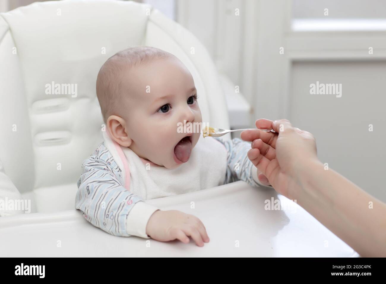 The boy eating food from a spoon Stock Photo - Alamy