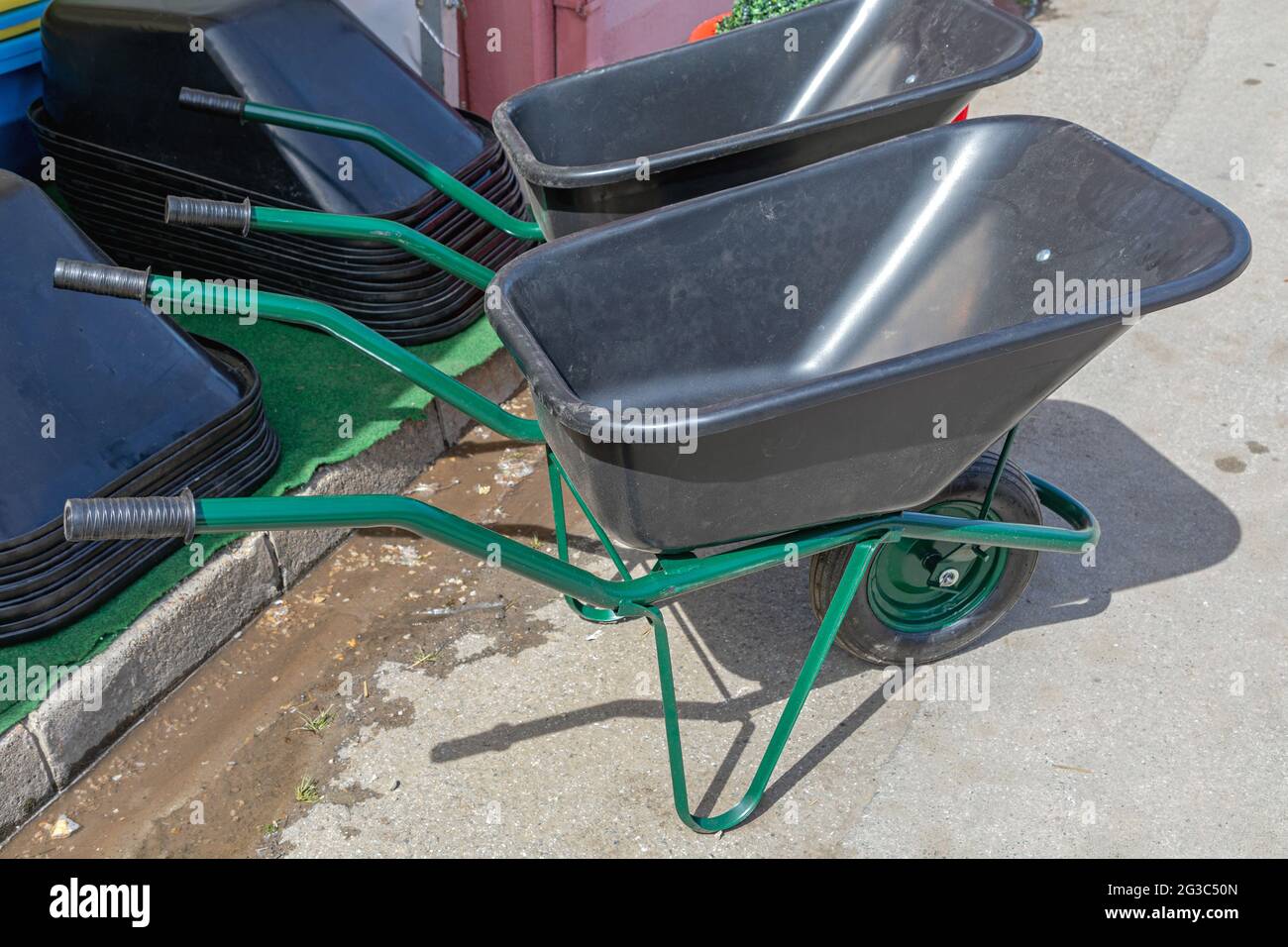 Wheelbarrow With Black Plastic Bucket for Gardening Stock Photo - Alamy