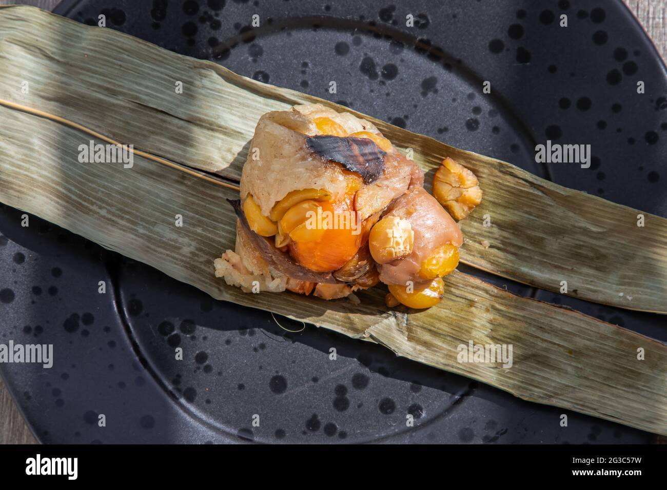 Chinese rice dumpling (Zongzi) shaped pyramidal wrapped by leaves ...