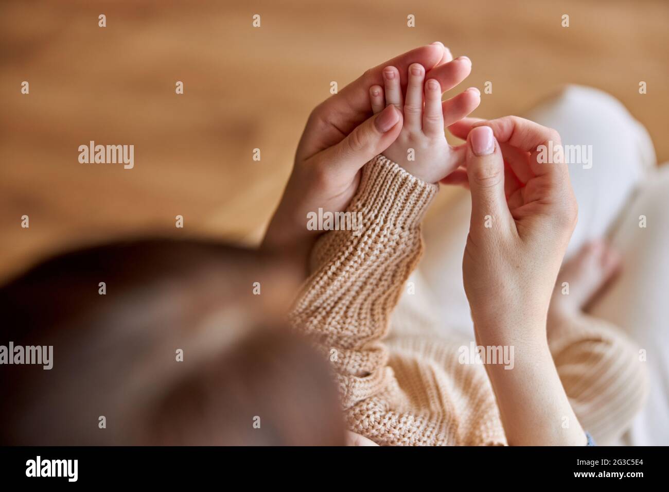 Mother touching small hand of her newborn baby Stock Photo - Alamy