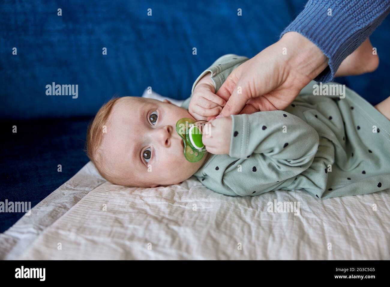 Mother giving pacifier into mouth of newborn baby Stock Photo - Alamy