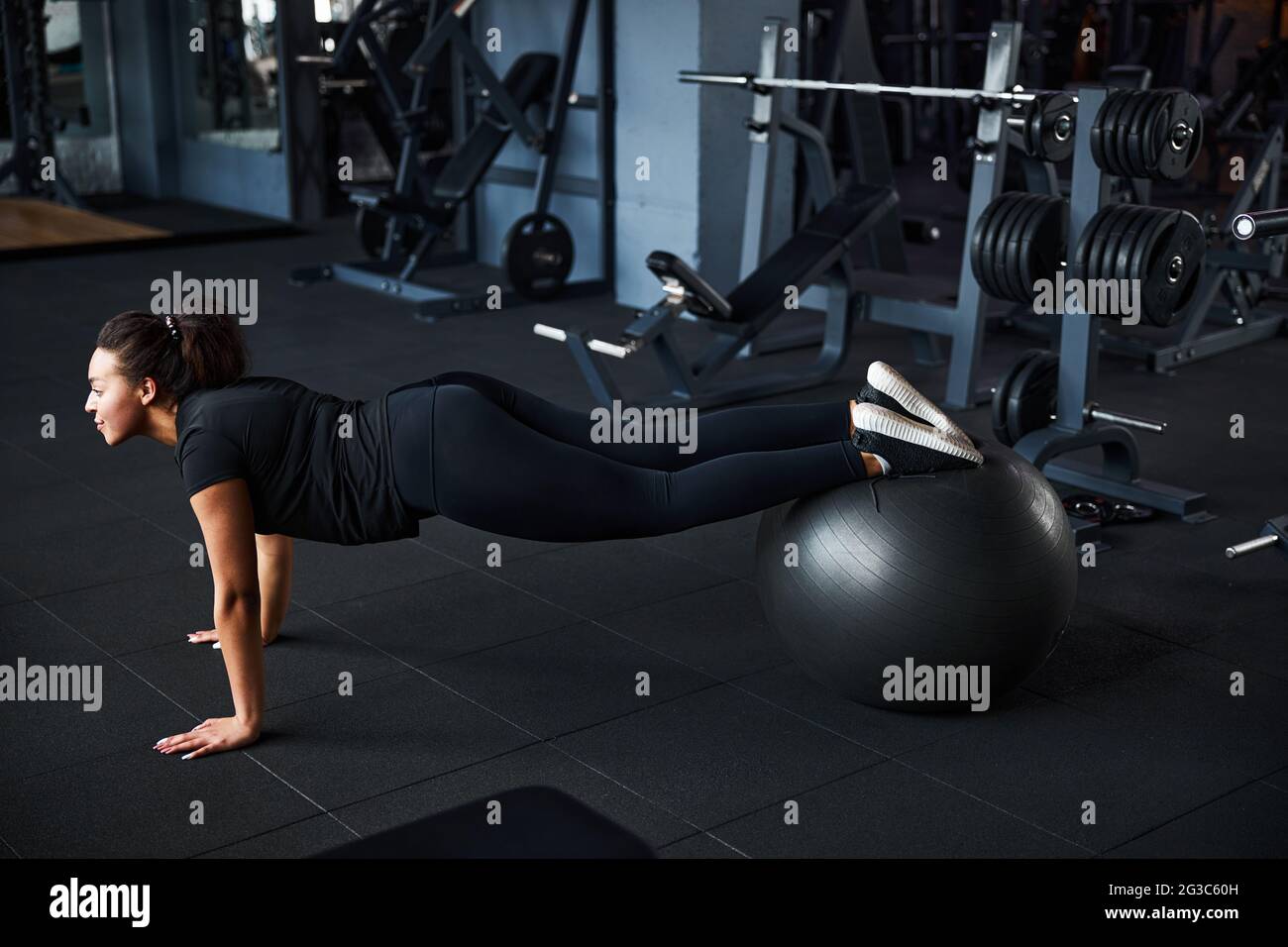 Sporty pretty female exercising core in gym Stock Photo - Alamy