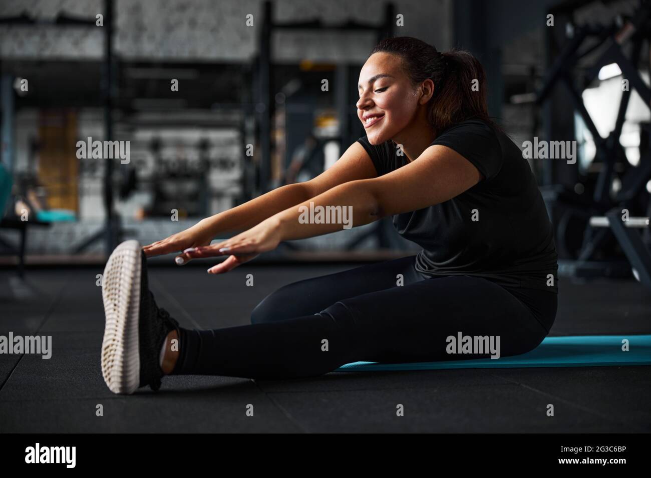 Cheerful young woman exercising hi-res stock photography and images - Alamy
