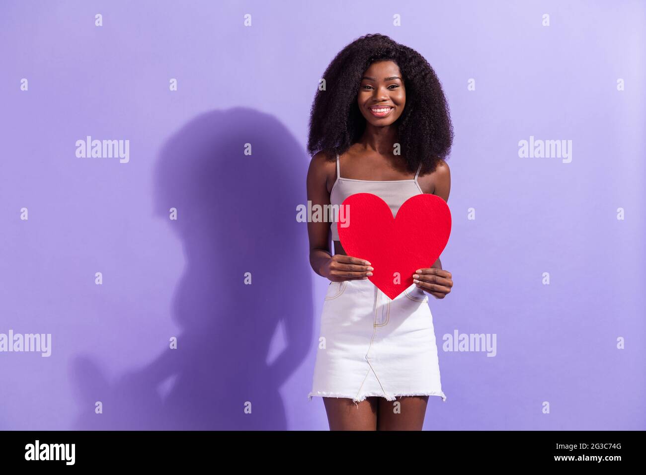 Photo of young cheerful afro woman happy positive smile hold big red ...