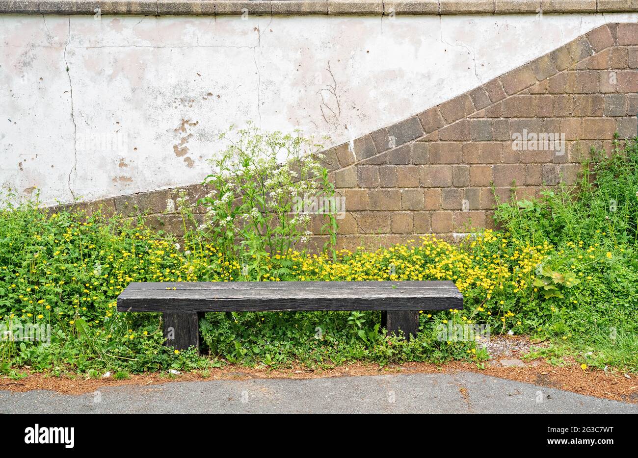 Wooden bench seat in town car park Stock Photo - Alamy