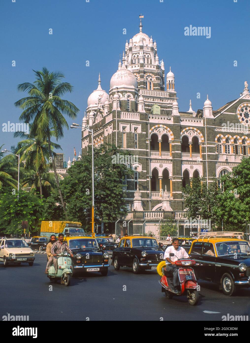MUMBAI, INDIA - Taxis and scooters on street in front of BB&CI Rail ...