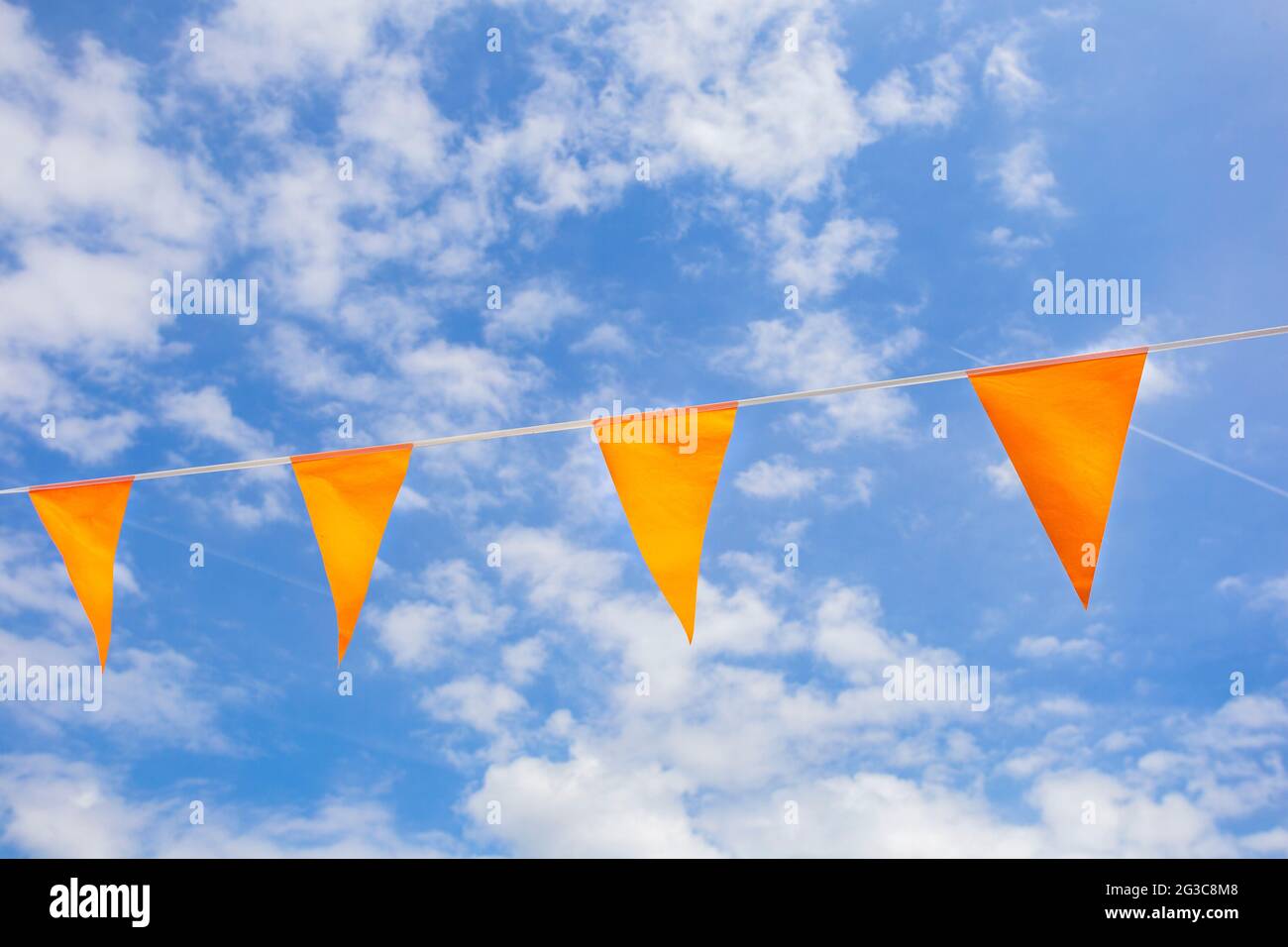 Flags in Dutch national color orange in the clear blue sky with ...