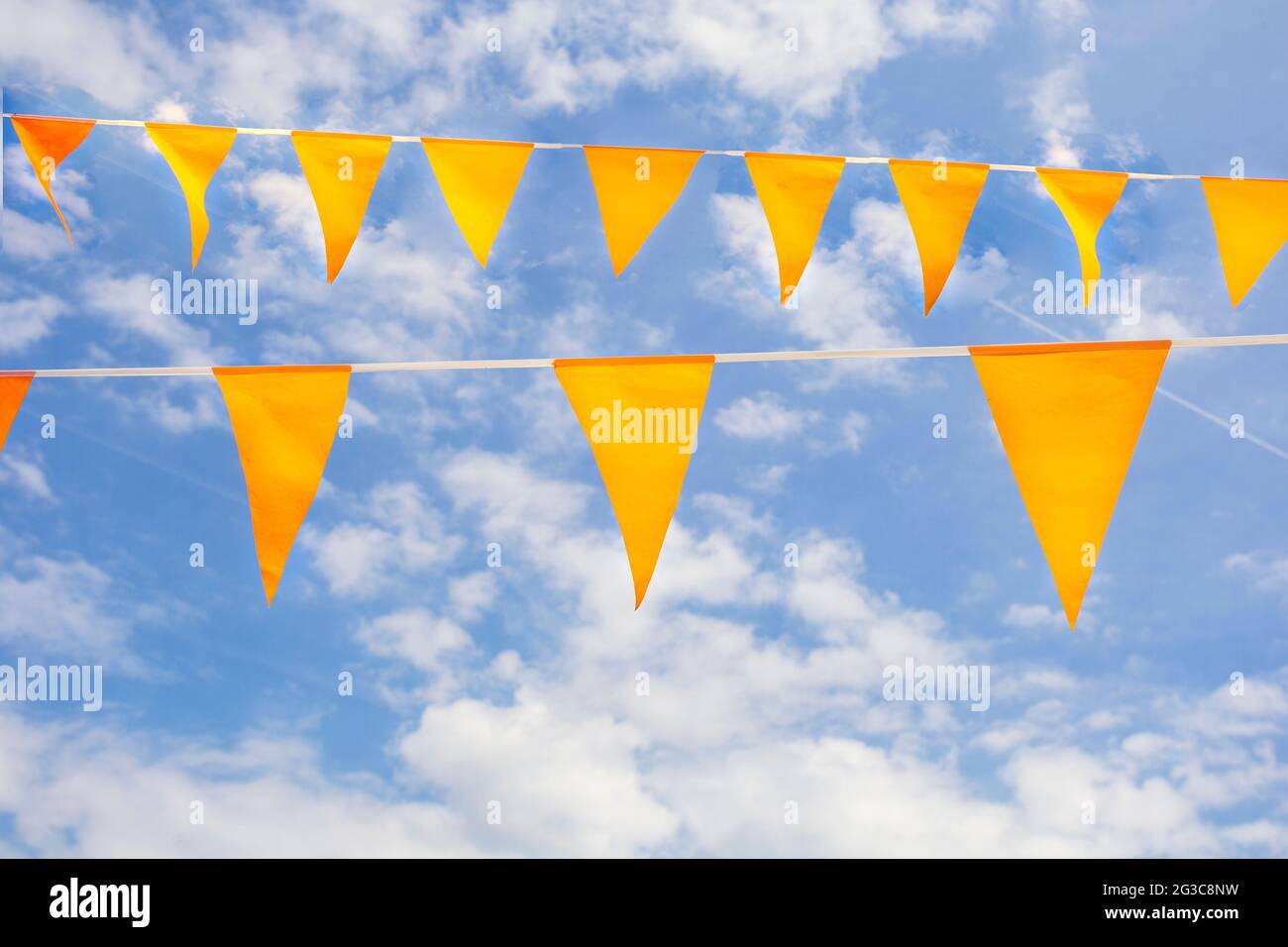Flags in Dutch national color orange in the clear blue sky with ...