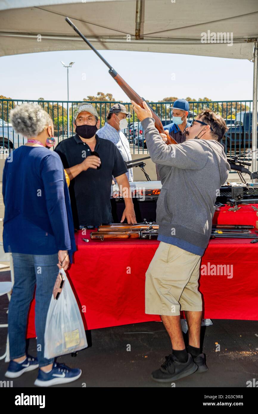 Weapons and ammunition are on exhibit and for sale at an outdoor gun ...