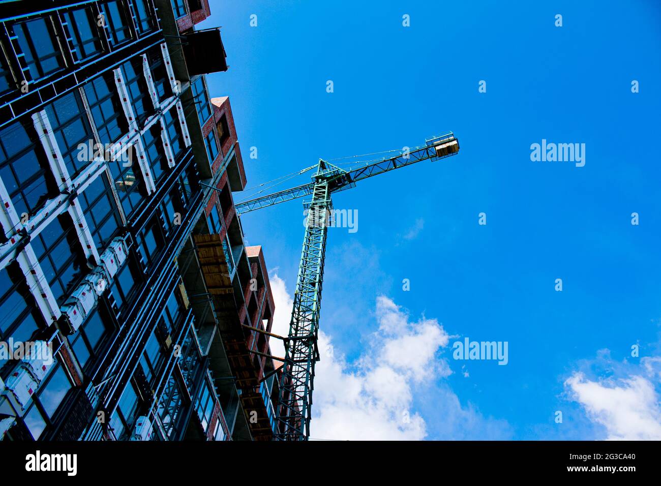 Crane and building construction. Construction of a large building Stock ...
