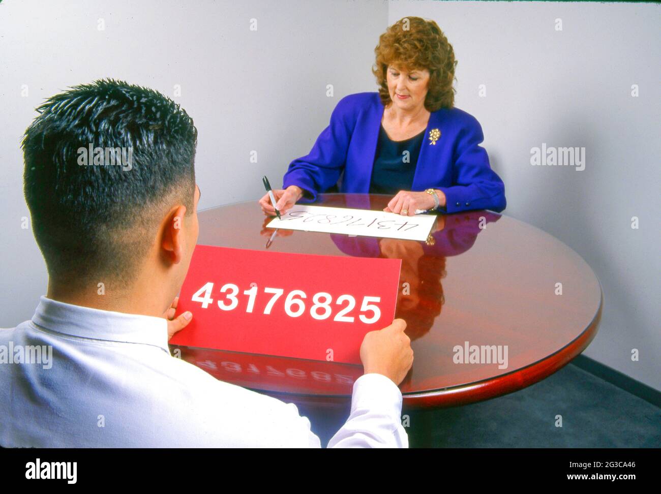 A woman takes a test to determine her ability to remember numbers. The ...