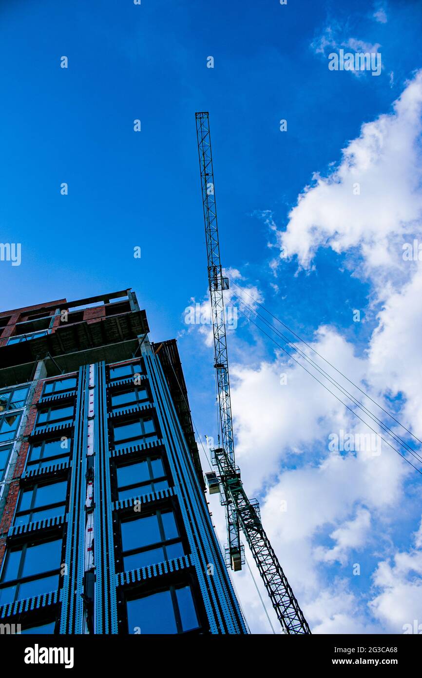 Crane and building construction. Construction of a large building Stock ...