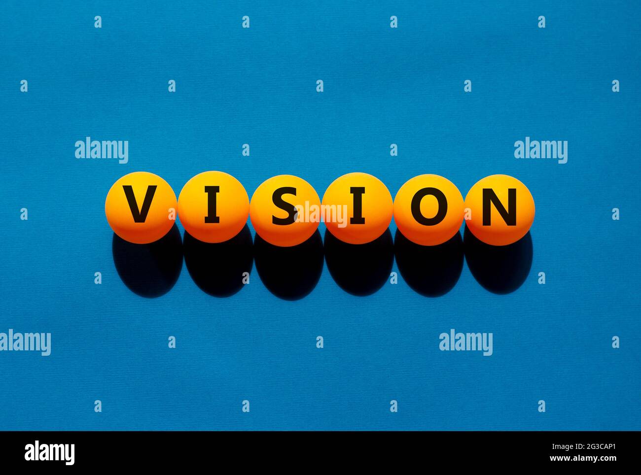 Vision and business symbol. The concept word 'vision' on orange table ...