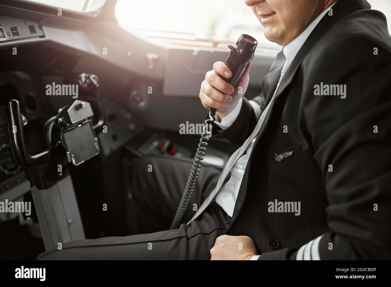 Pilot talk information on microphone to passengers Stock Photo - Alamy