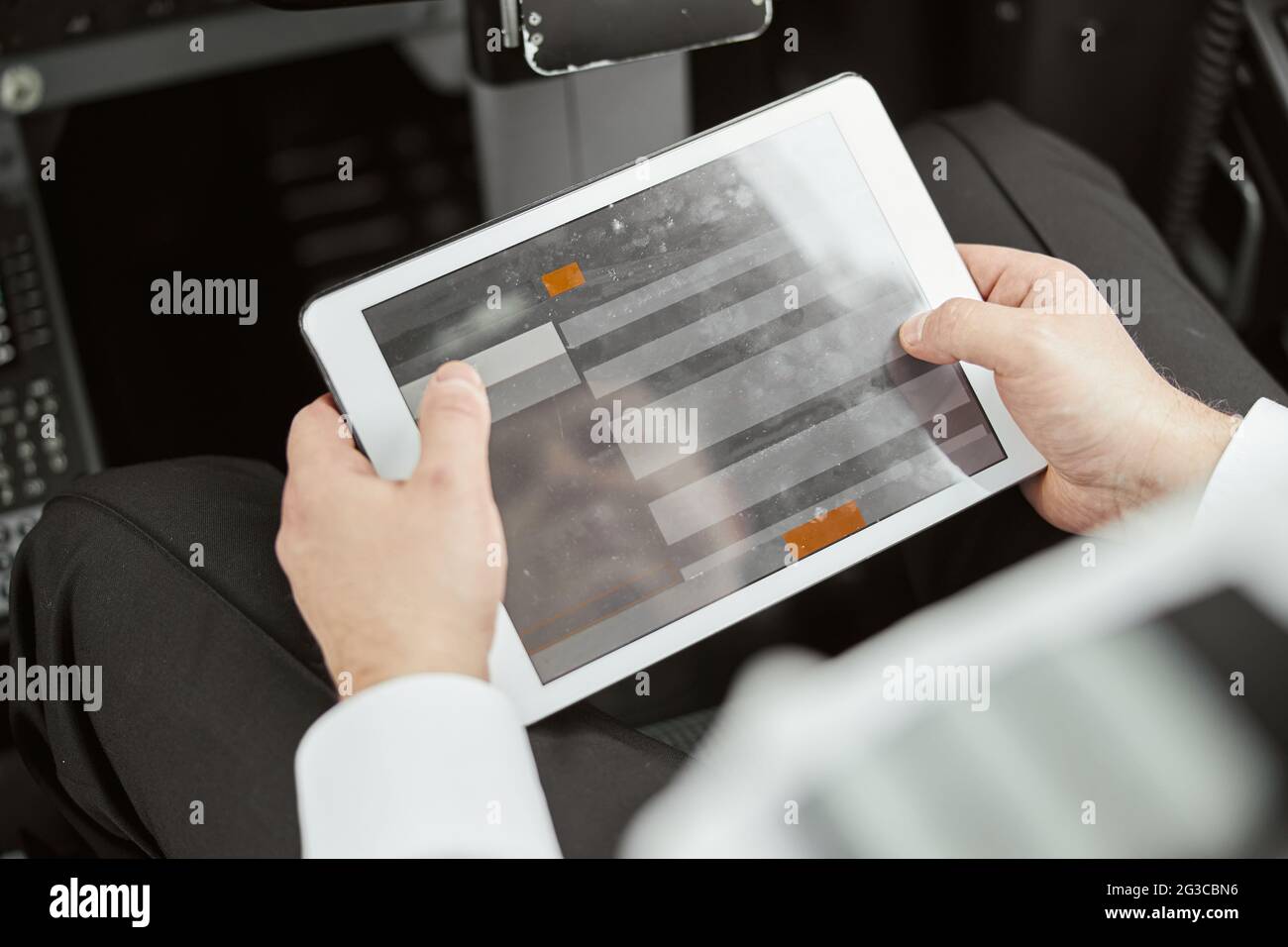 Pilot use digital tablet in passenger airplane jet Stock Photo - Alamy